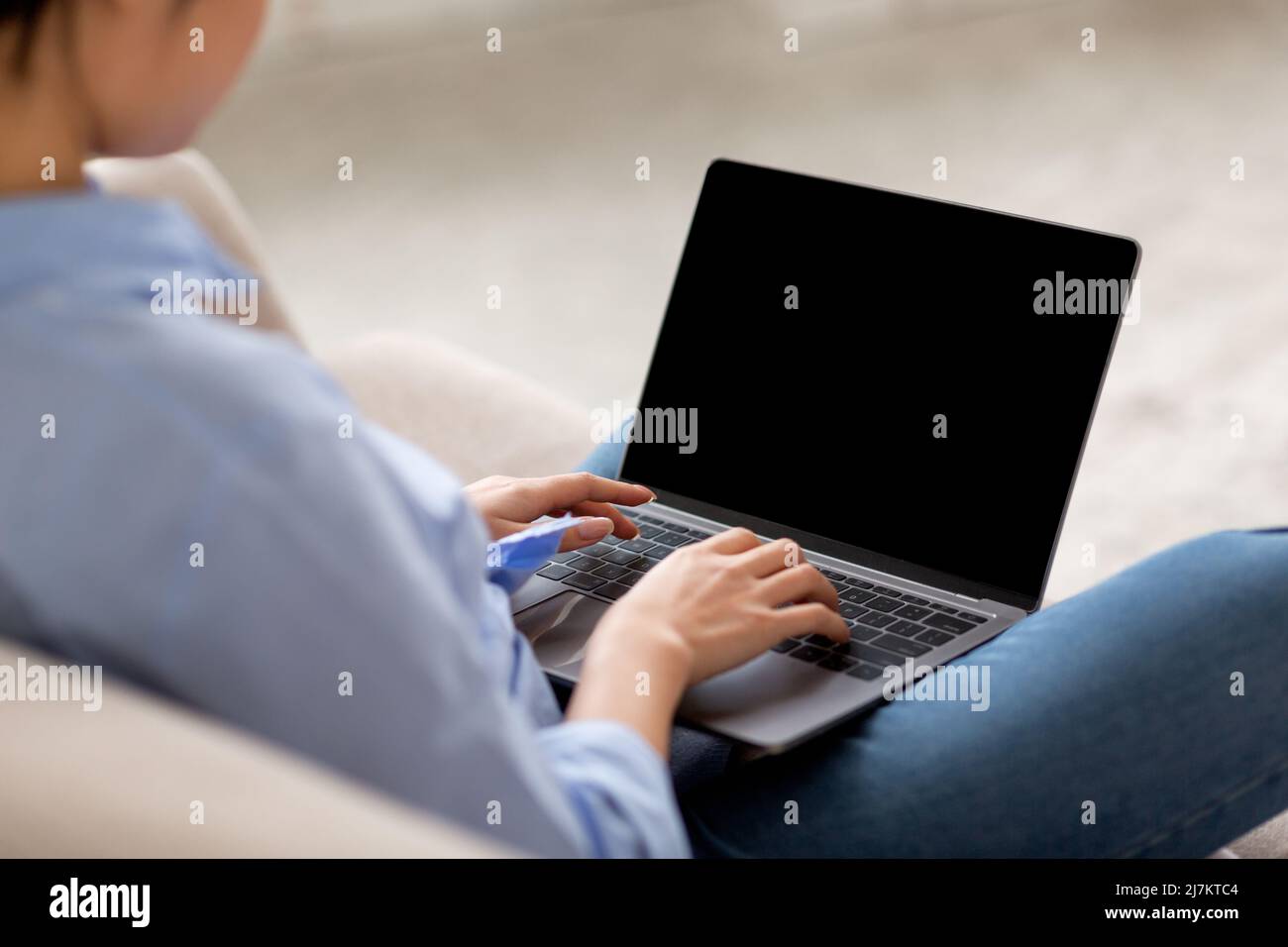 Over shoulder shot of woman using laptop, mockup Stock Photo - Alamy