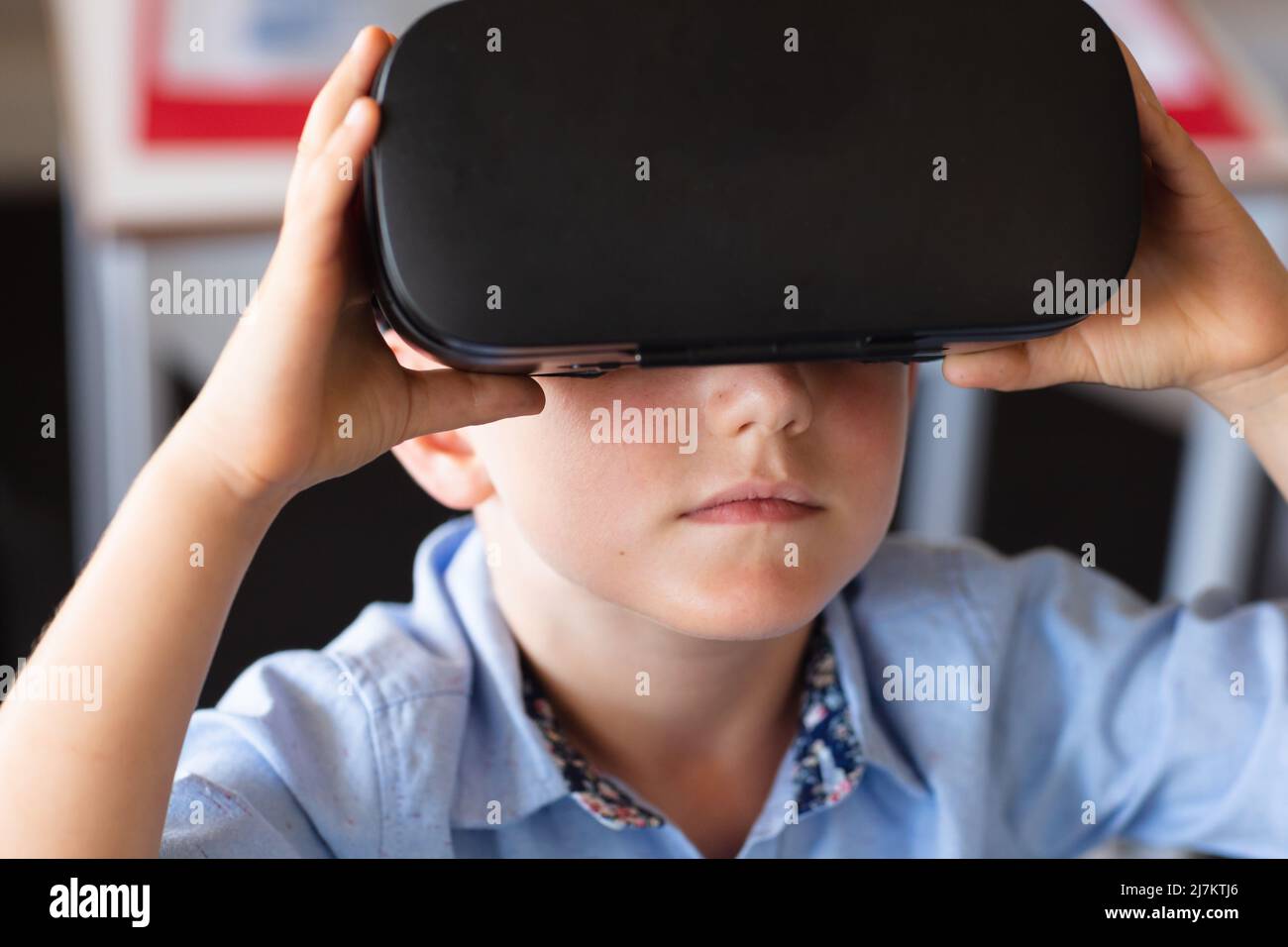 Close-up of african american elementary schoolboy wearing vr glasses in ...