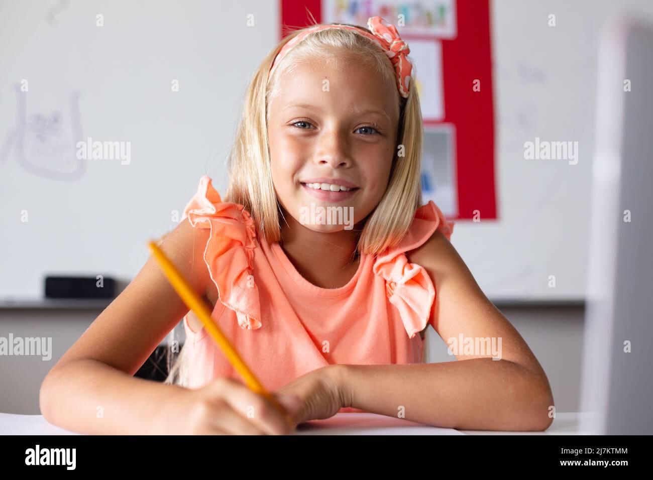 Portrait of smiling caucasian elementary schoolgirl with blond hair ...