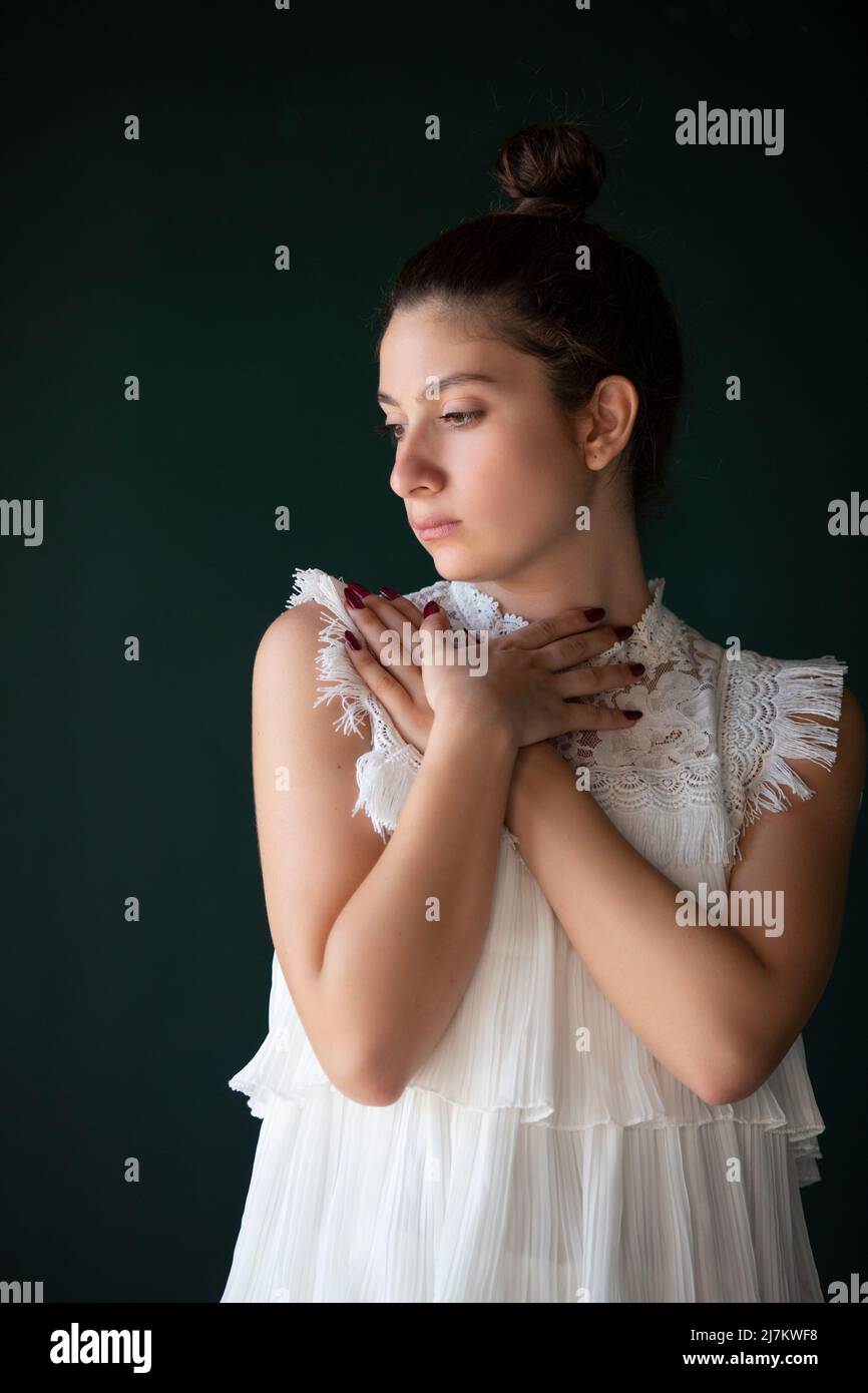 Sad woman hands over heart Stock Photo - Alamy