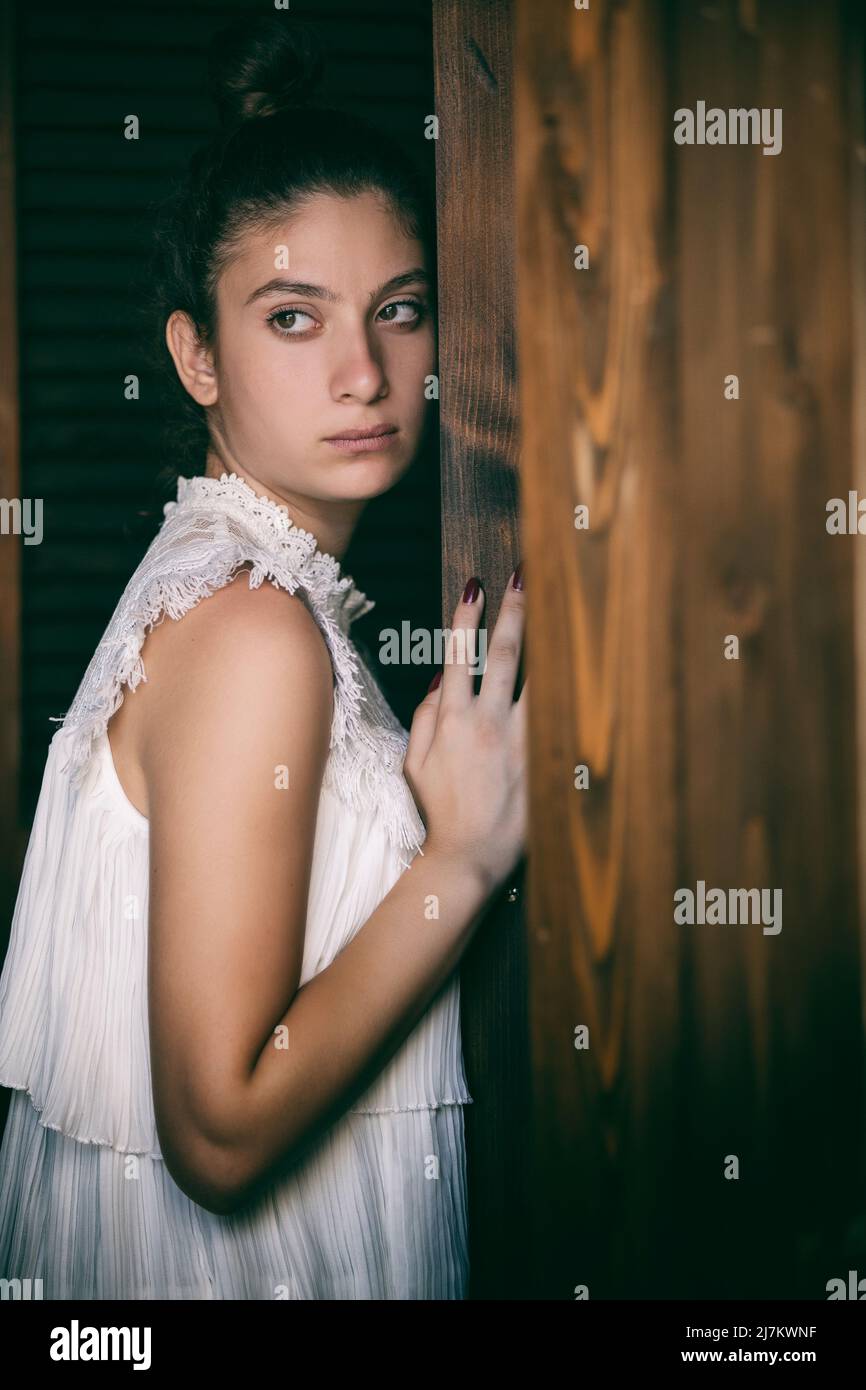 Sad woman by the door looking away Stock Photo - Alamy