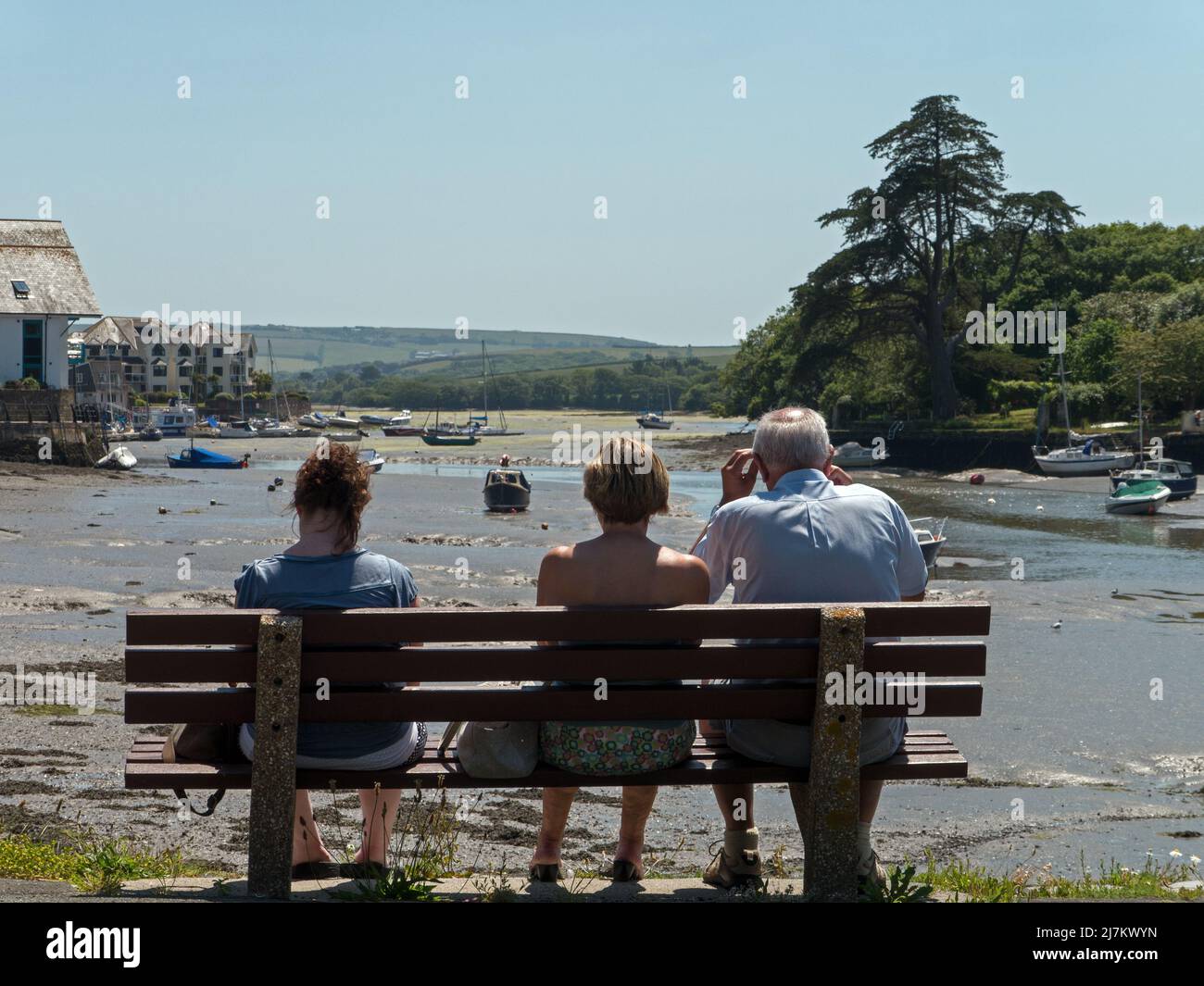Three People Seated overlooking the scenic Kingsbridge Estuary ...