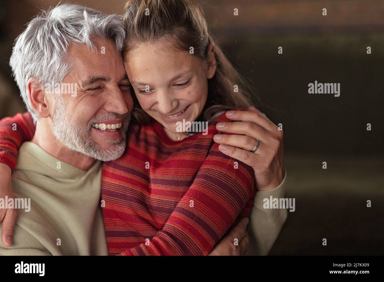 Portrait of teenage daughter hugging her happy father at home Stock ...