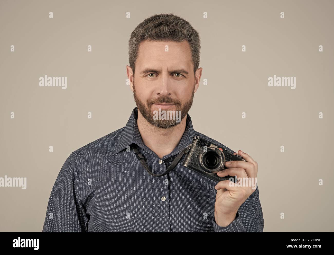 Bearded man in casual style hold compact photographic camera grey ...