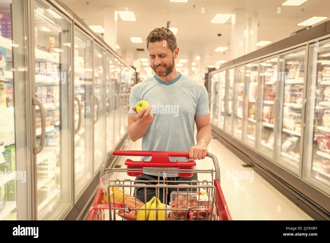 happy man with shopping cart hold apple. customer consumer with ...