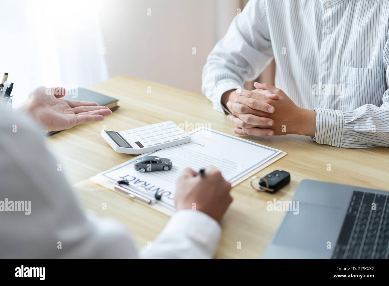 Insurance concept the car salesman describing the agreement on car ...