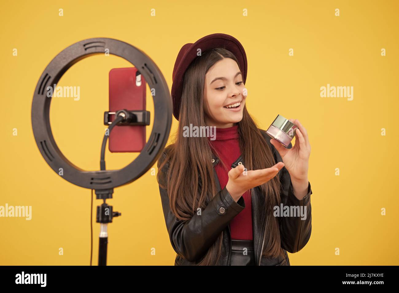 happy teen girl blogger use selfie led lamp and smartphone on tripod ...