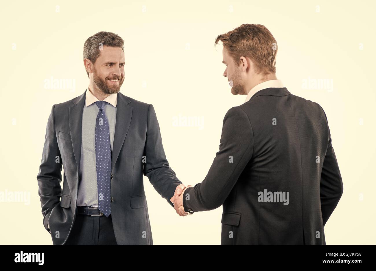 two businessmen colleagues shaking hands after successful business deal ...