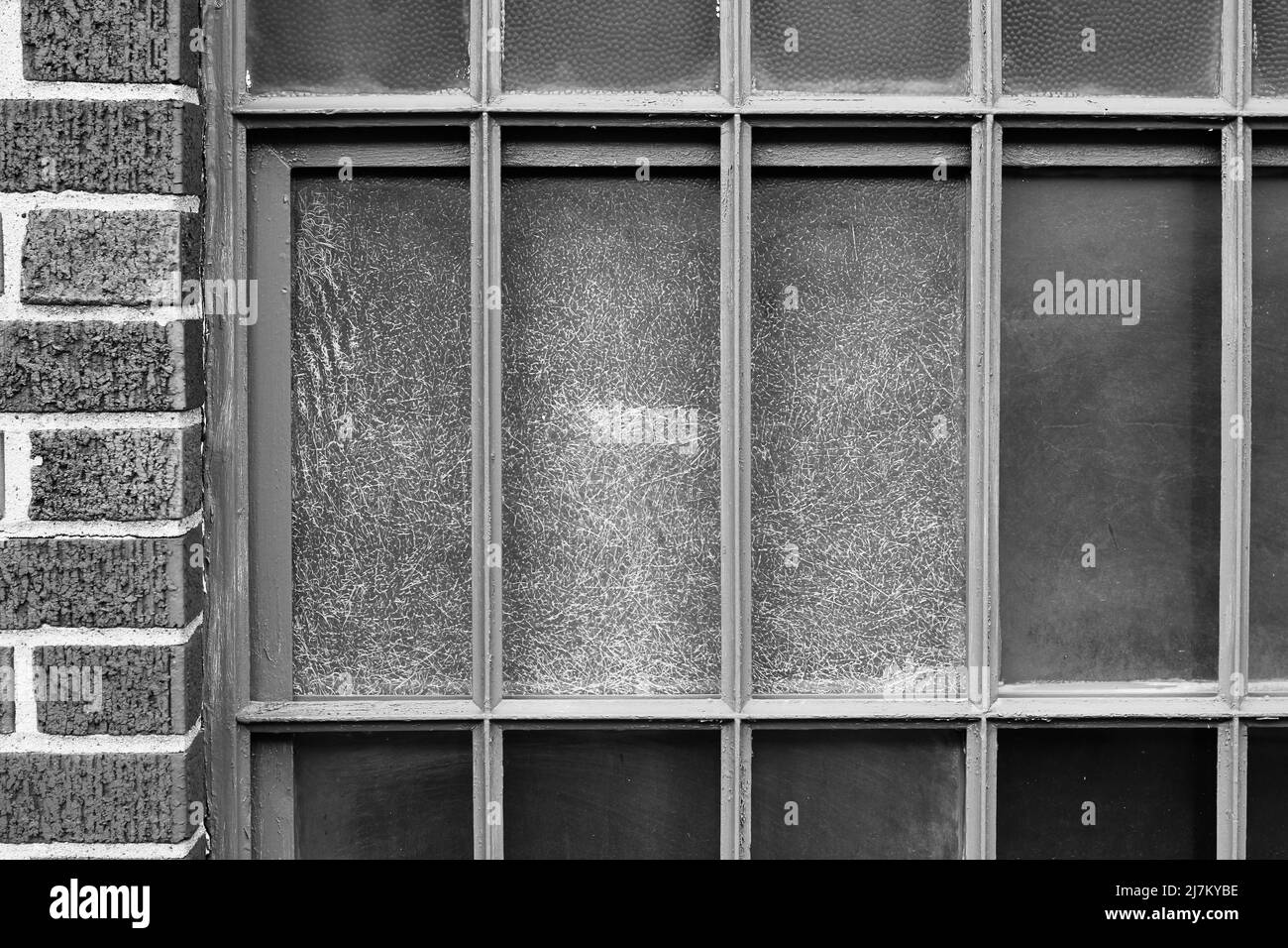 Worn old weathered pane glass window on the wall of an abandoned ...