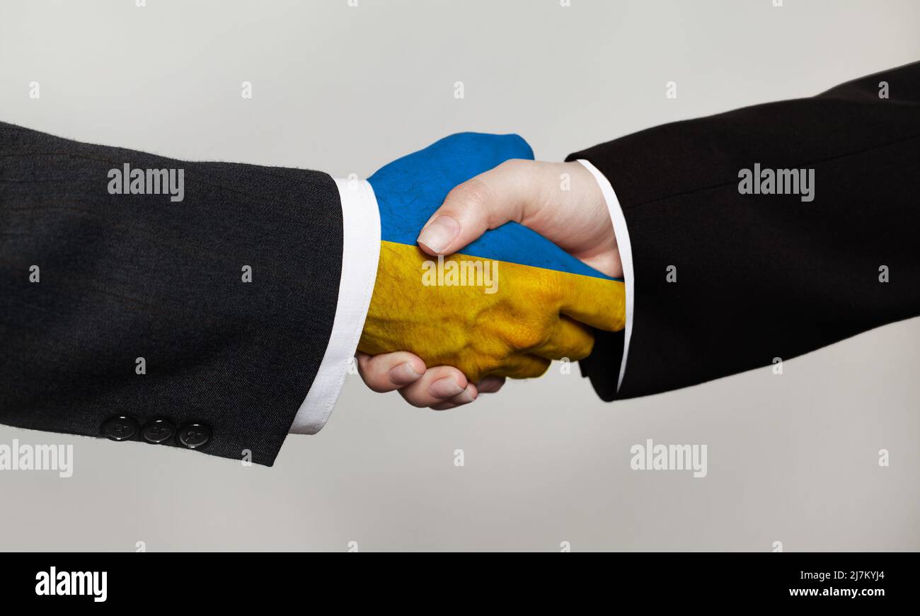 Flag Ukraine and handshake, partnership, friendship and support concept ...