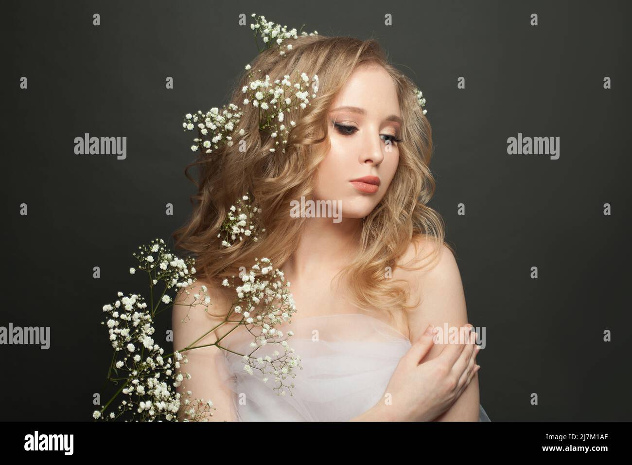Pretty young woman with white flower. Perfect female model with natural ...