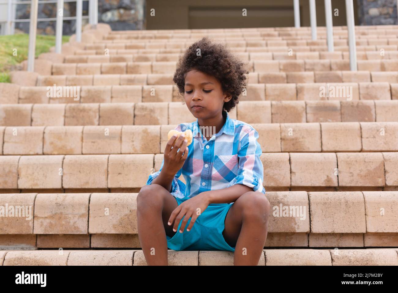 Children sitting on steps eating hi-res stock photography and images ...