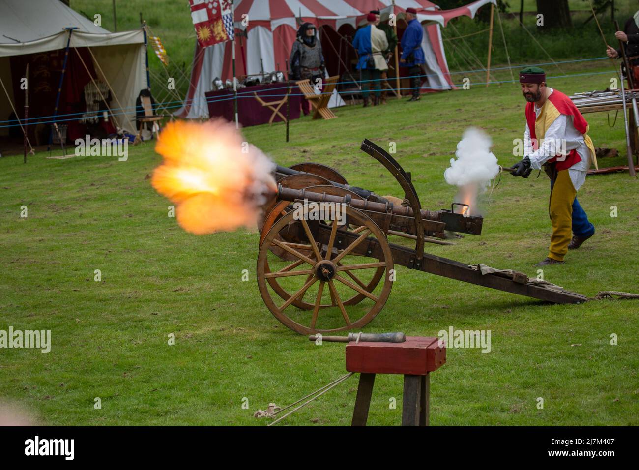 men and women firing muskets and wooden cannons during a re enactment ...