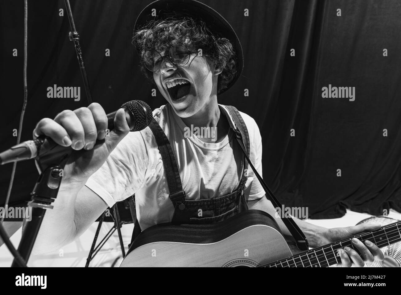 Repetition of retro music band at music studio. Young musician playing ...