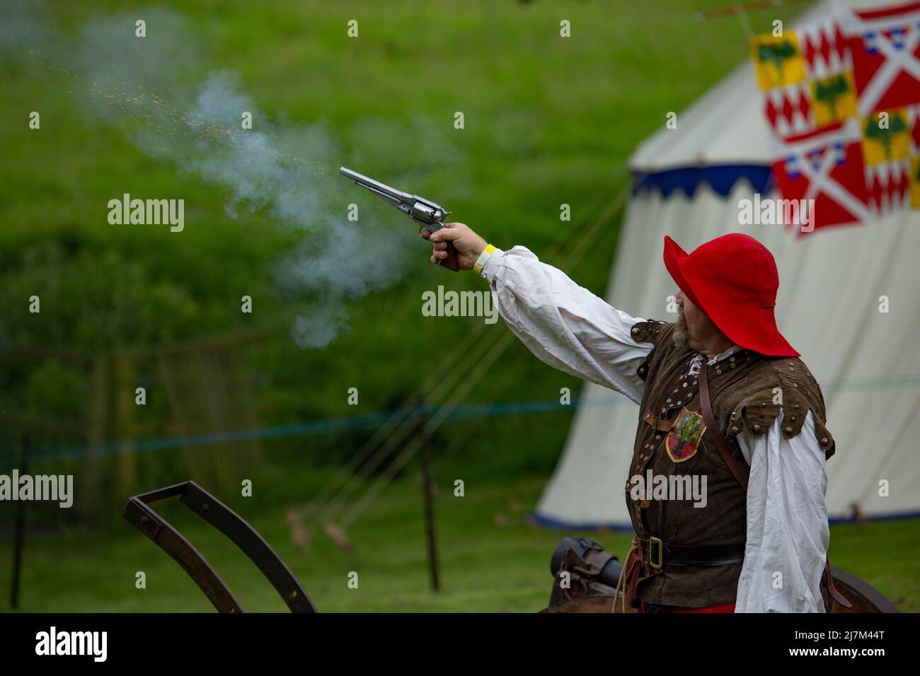 men and women firing muskets and wooden cannons during a re enactment ...