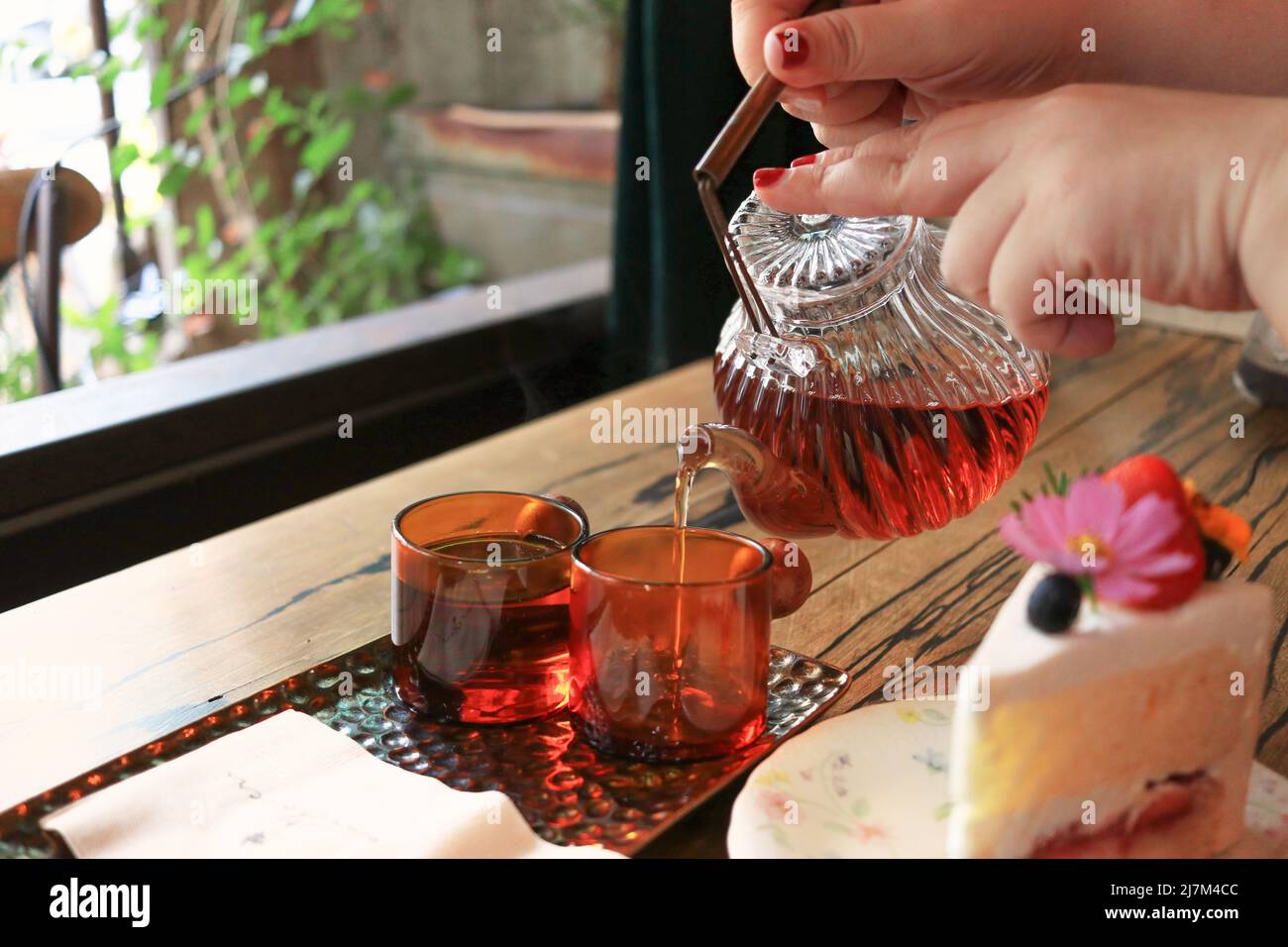 Two cups and pouring tea hi-res stock photography and images - Alamy