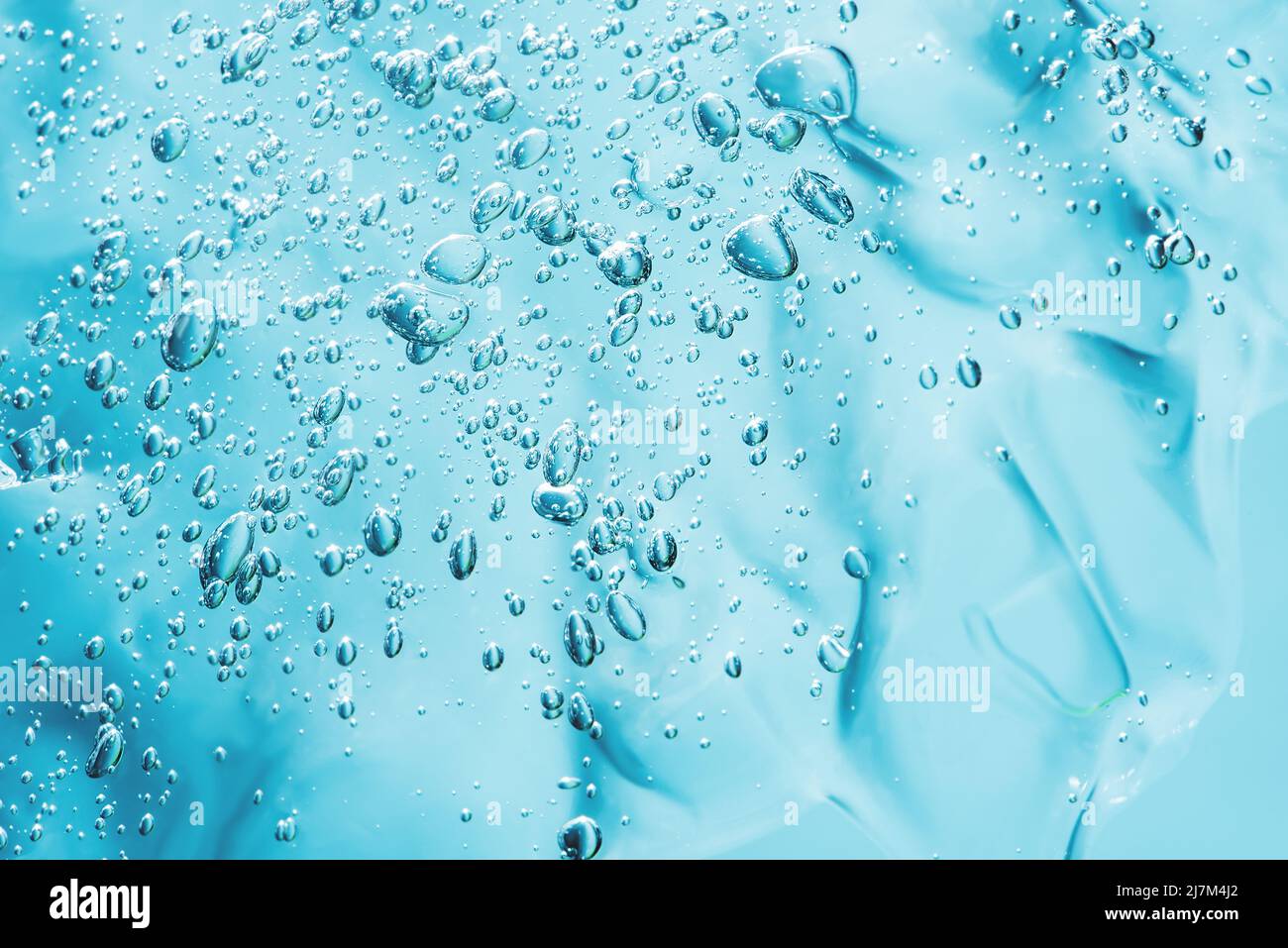 Close up macro Aloe vera gel cosmetic texture blue background with ...