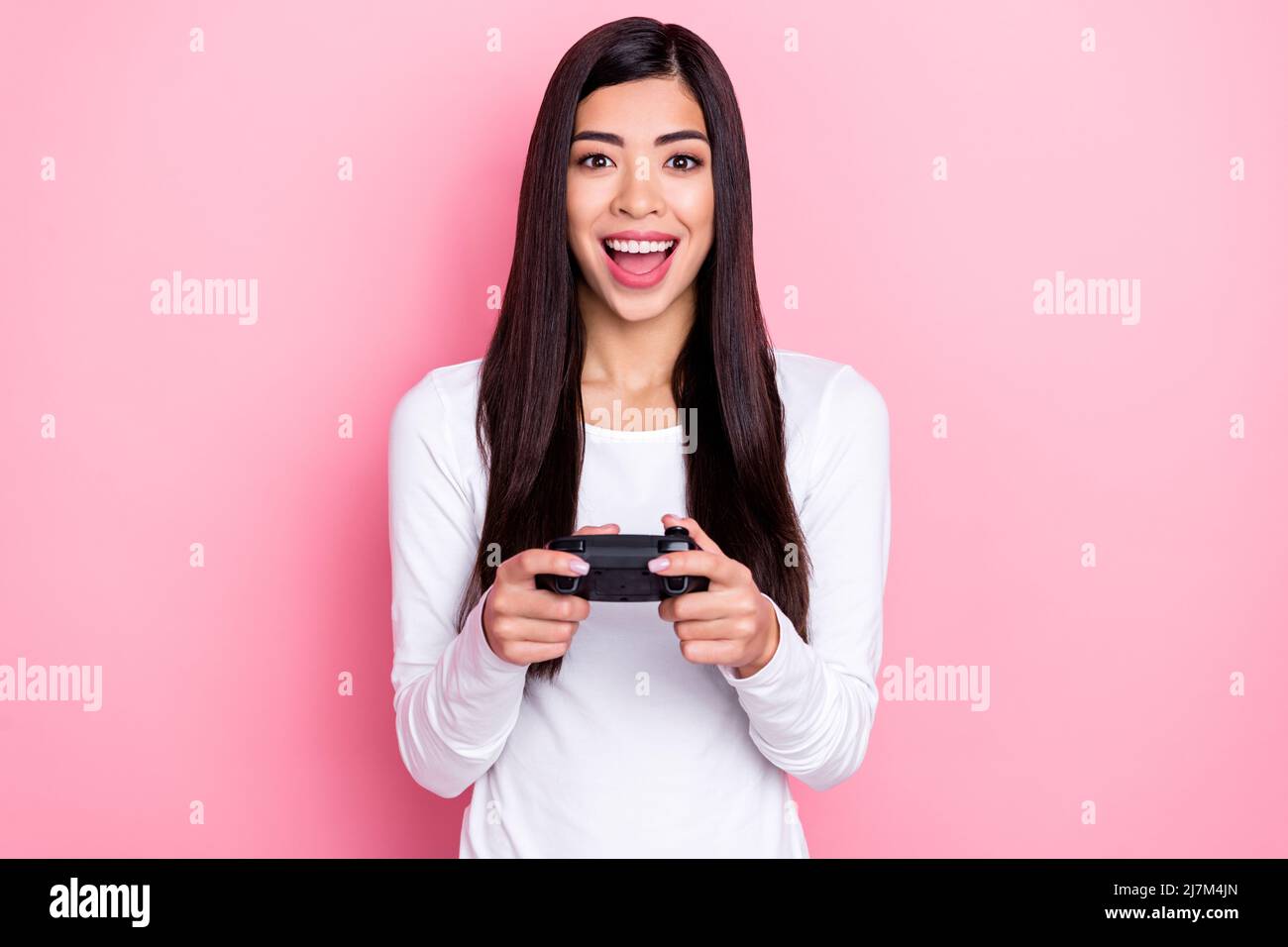 Photo of impressed young brunette lady playstation wear white shirt ...