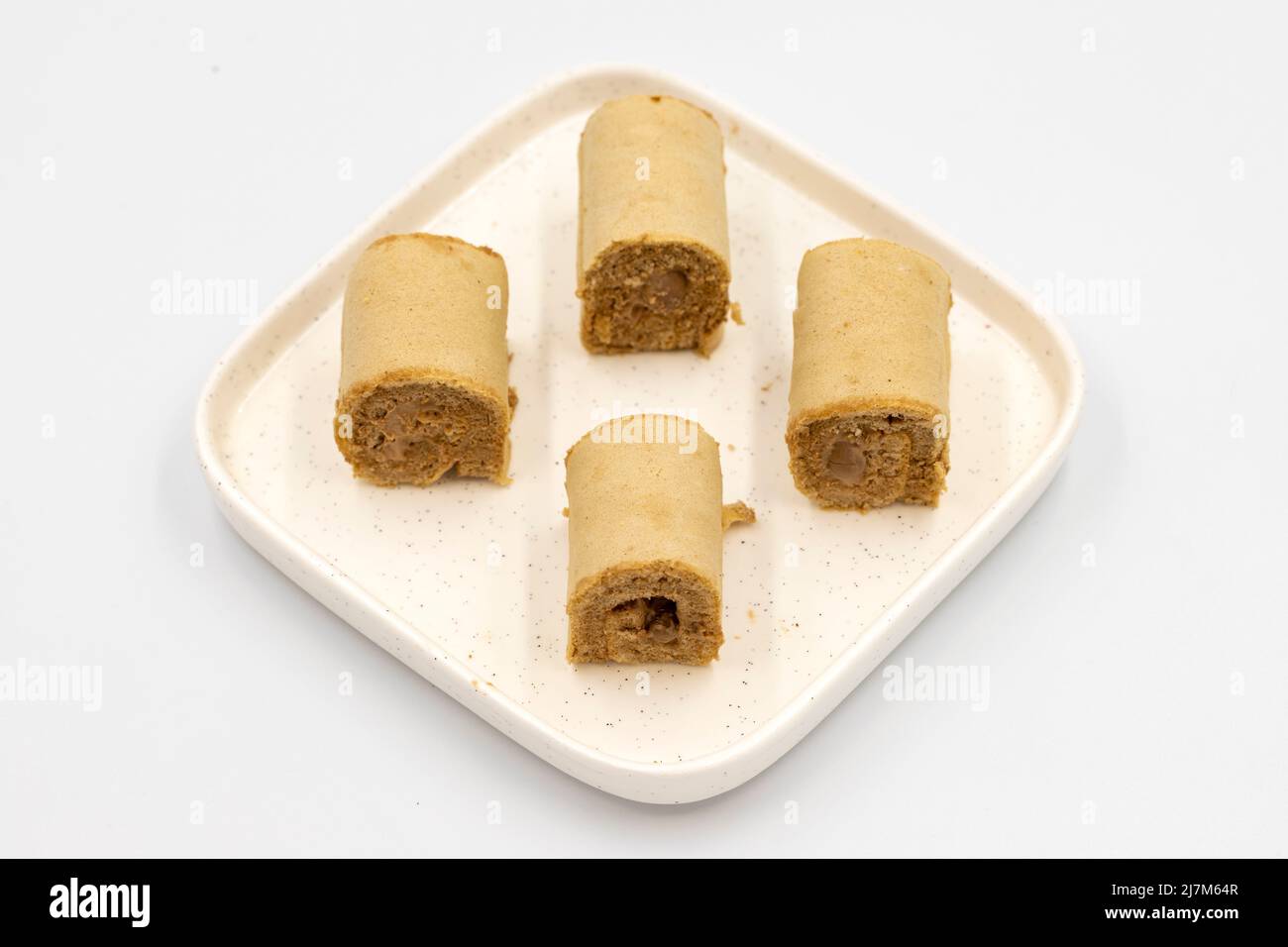 Roll cake with hazelnut and chocolate filling. roll cake on a white ...
