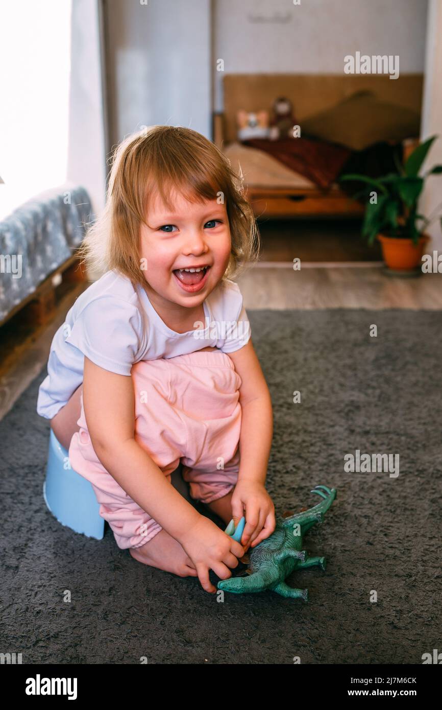 Cute toddler girl, potty training, playing with his toys on potty Stock ...