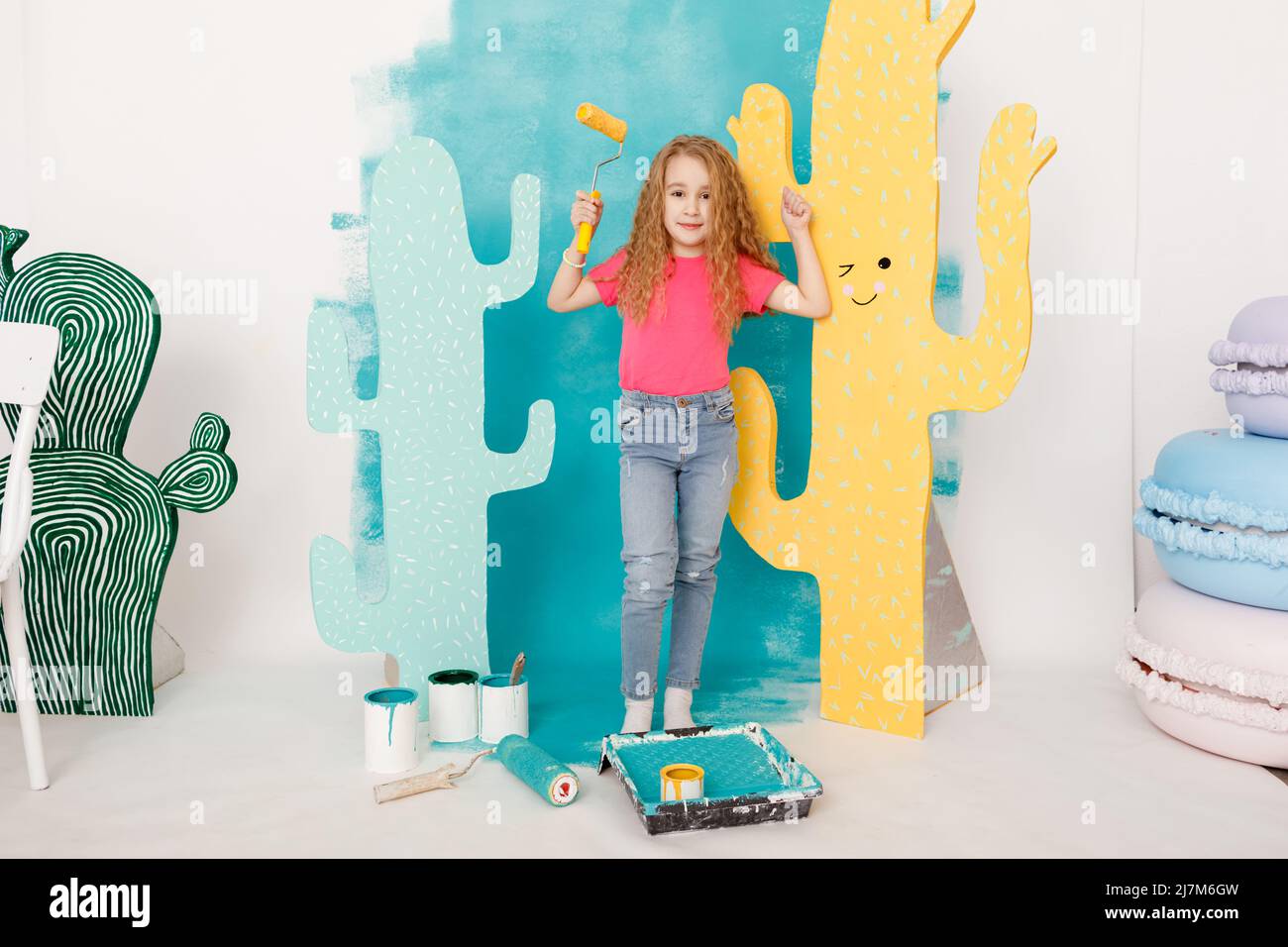 adorable little girl is doing repairs in the apartment fun paints the ...