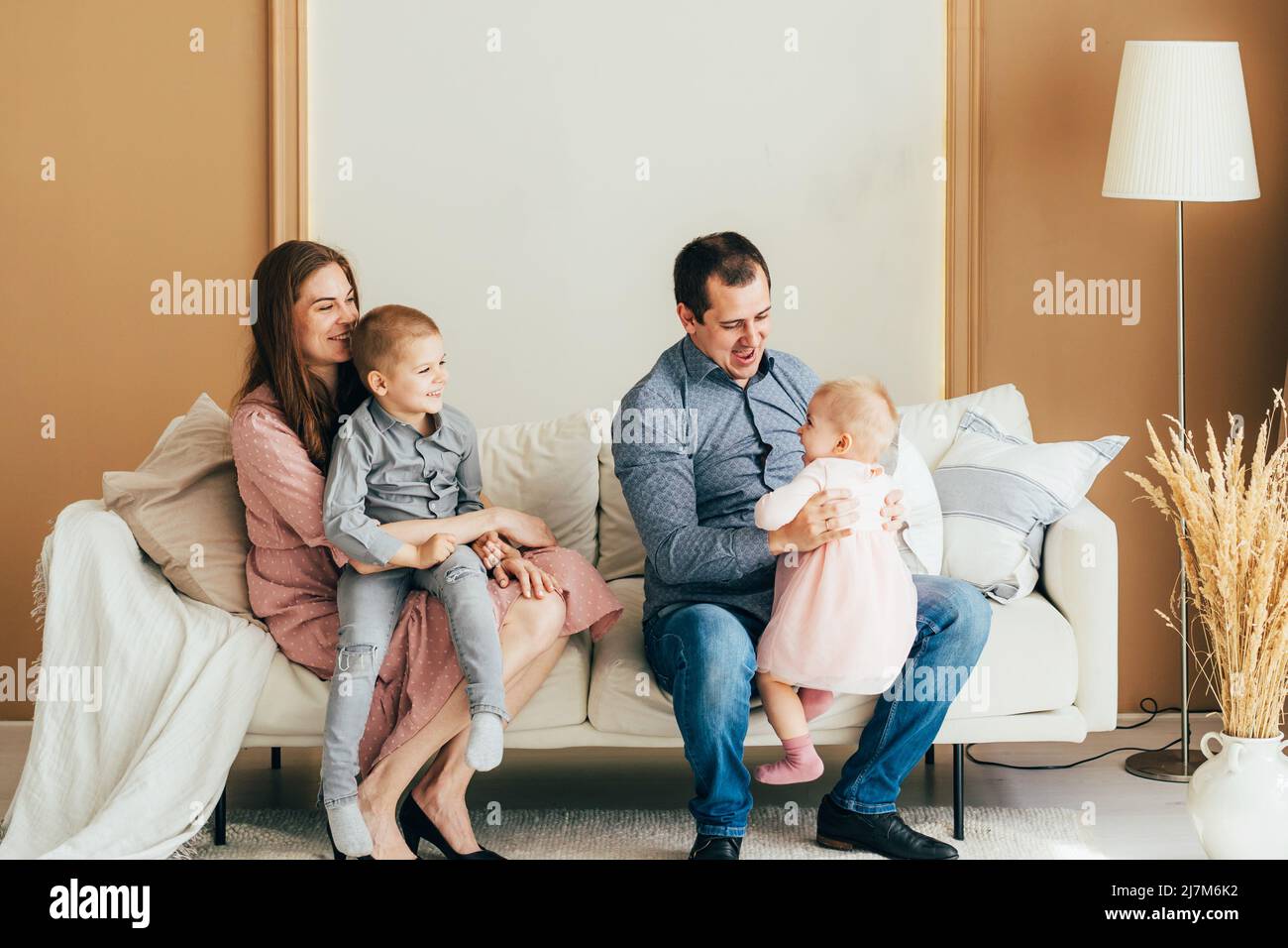 Cheerful happy european family parents with children have fun sitting ...