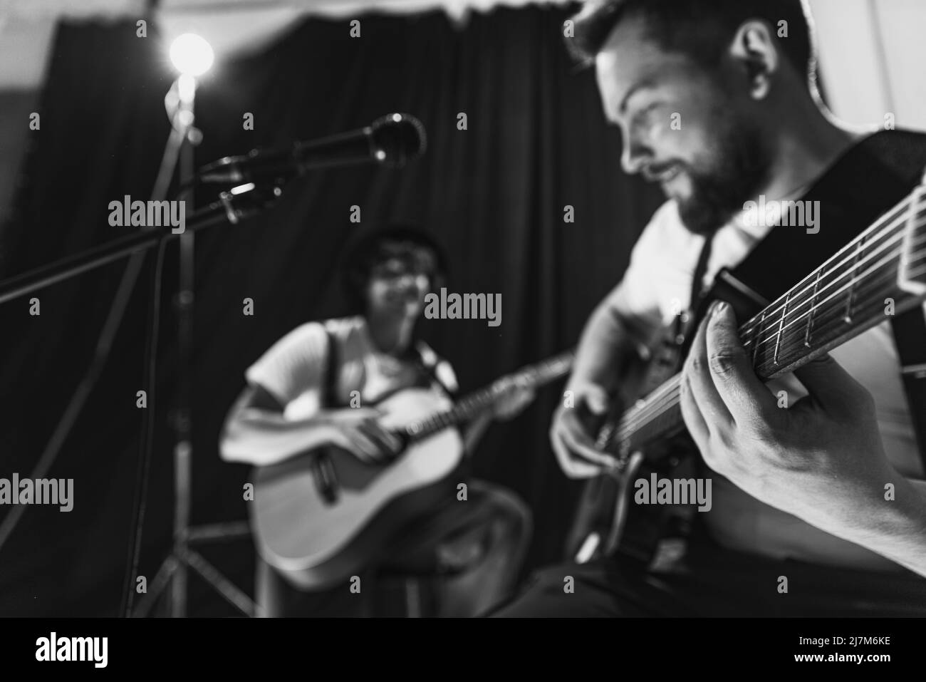 Close-up men, electric and acoustic guitar players at concert ...