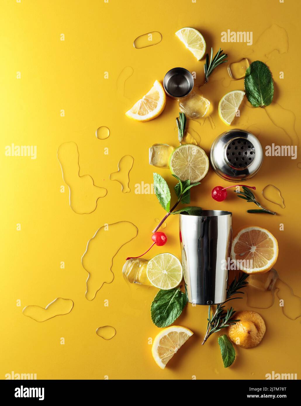 Shaker with ingredients for making cocktails on a yellow background ...