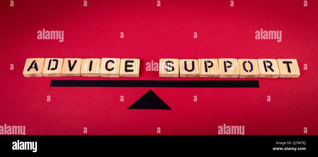 Advice and Support balance. Text on a red background Stock Photo - Alamy