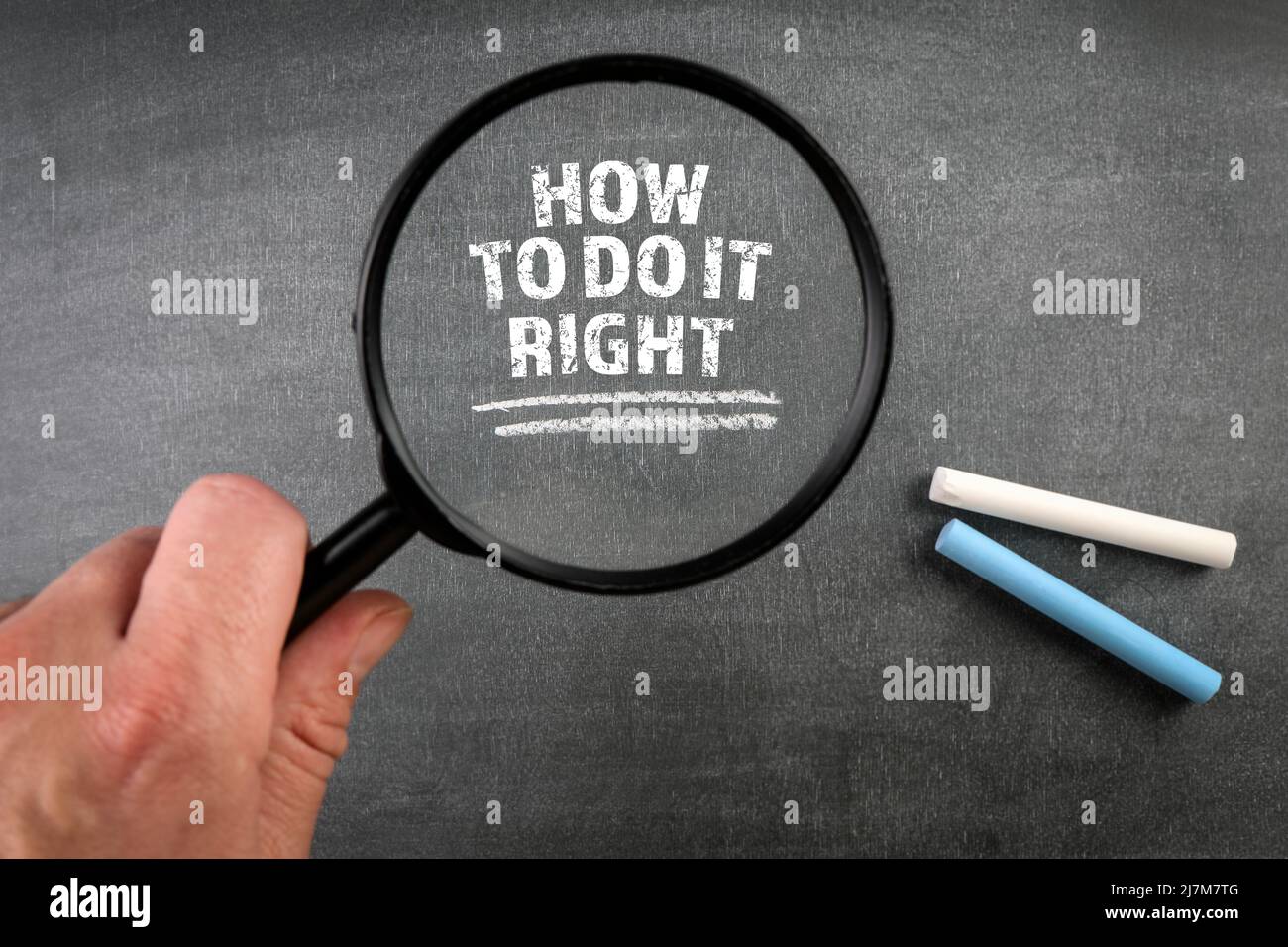 HOW TO DO IT RIGHT. Magnifying glass and white pieces of chalk on a ...