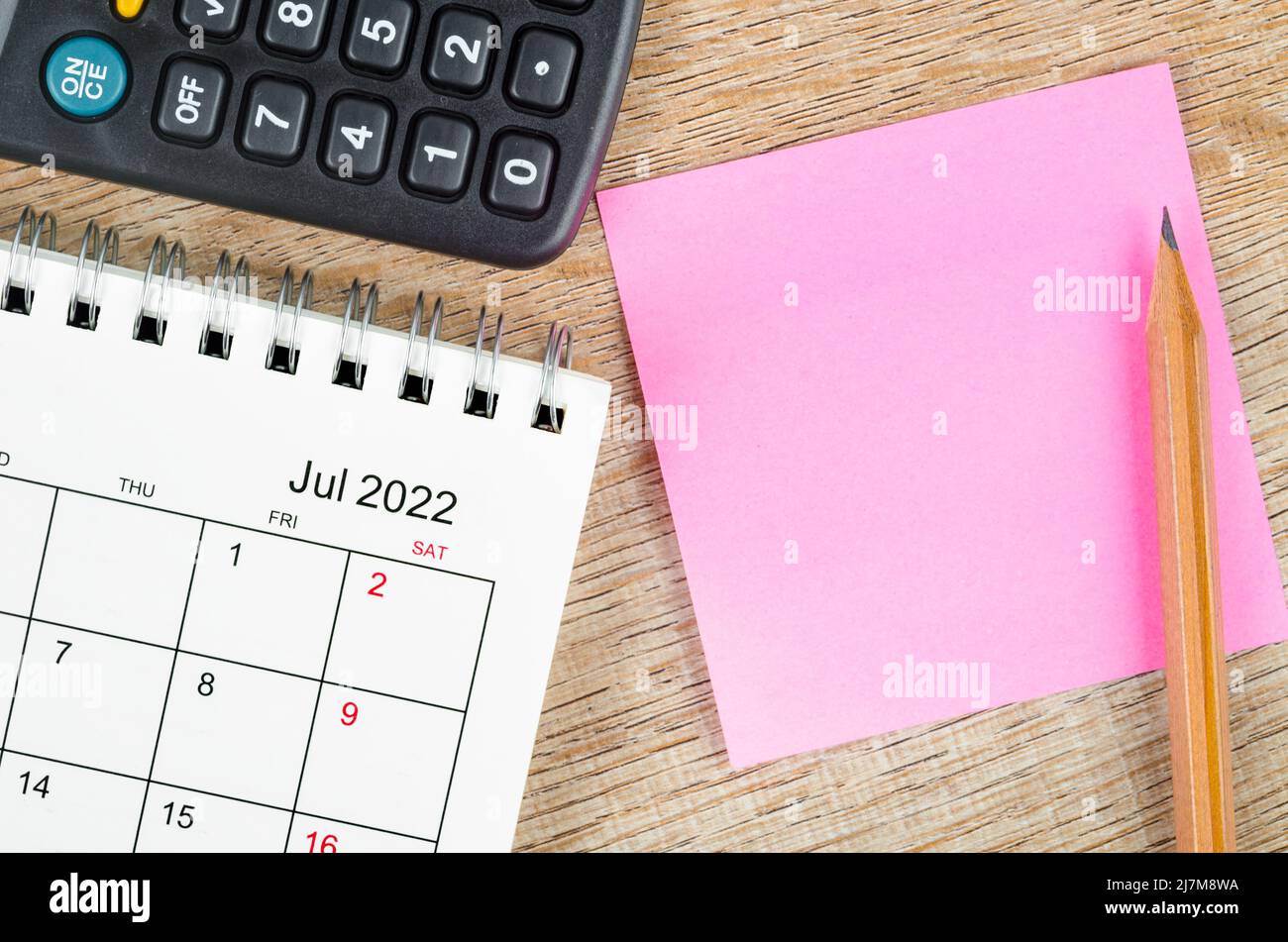 The Blank sticky note on July 2022 desk calendar on wooden background ...