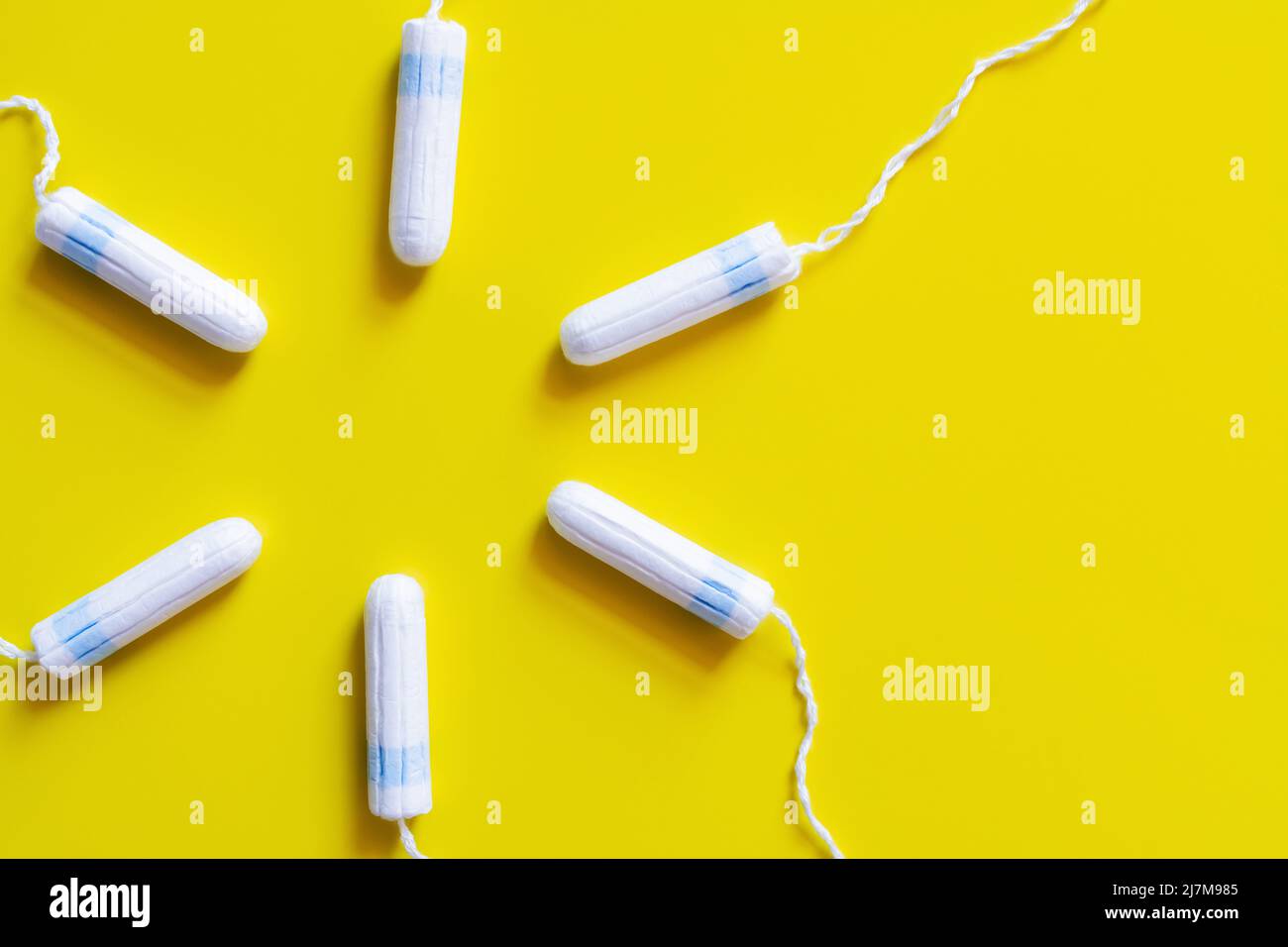 circle of hygienic tampons on bright yellow background, top view Stock ...