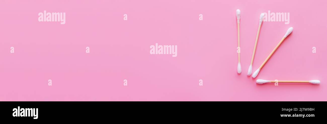top view of cosmetic cotton swabs on pink background with copy space ...