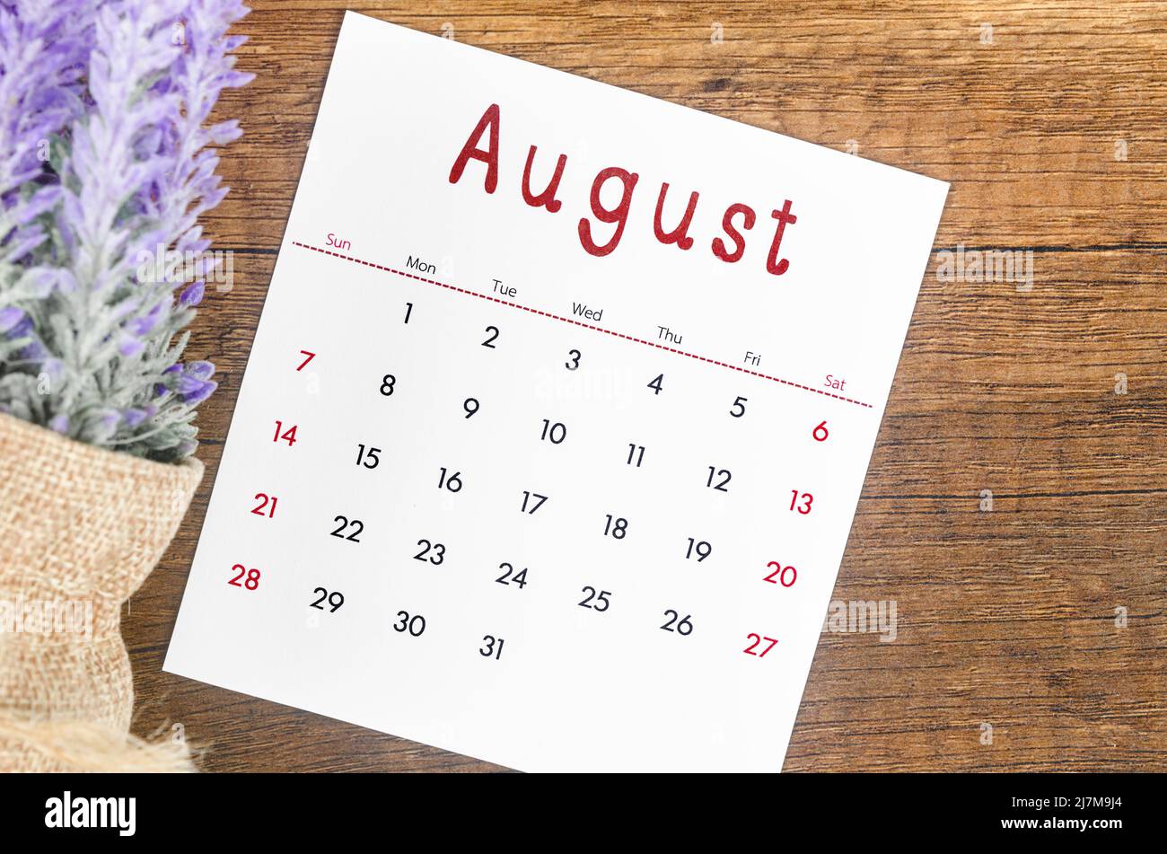 The August 2022 calendar with flower on wooden background Stock Photo ...