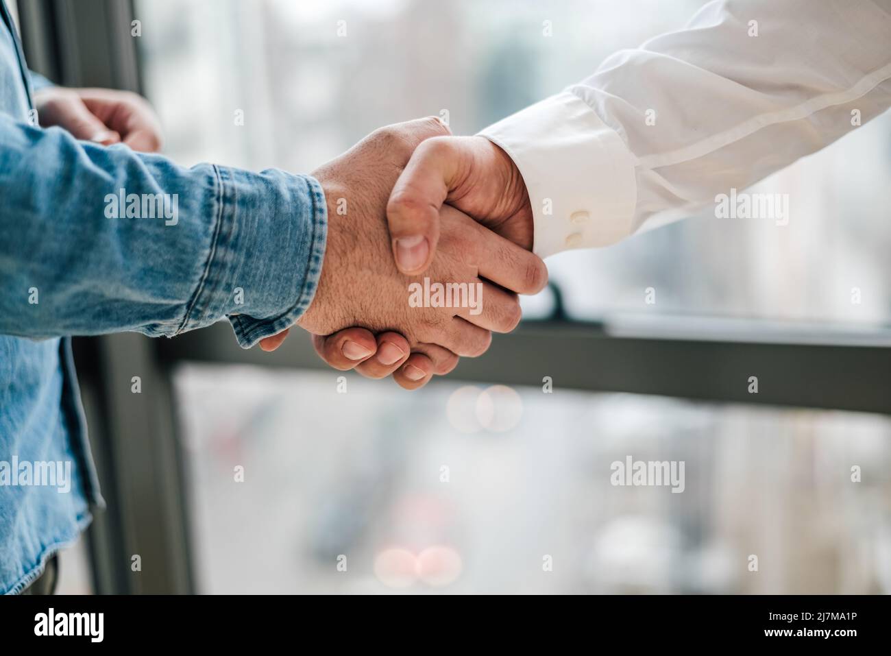 Close up shot of teamwork handshake in the office businessman ...