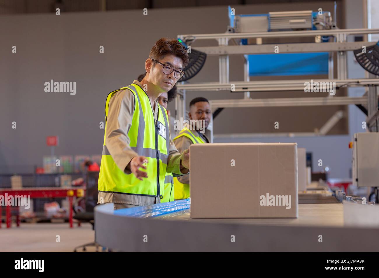 Asian mature man with african american young male coworker processing ...