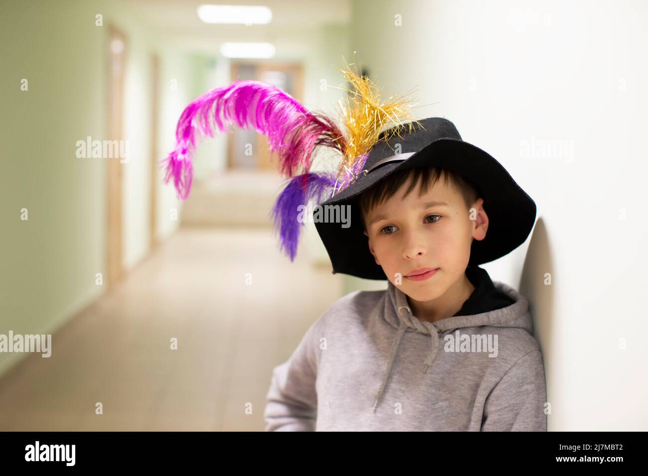 Little boy in a theater hat with feathers. Young artist from the ...