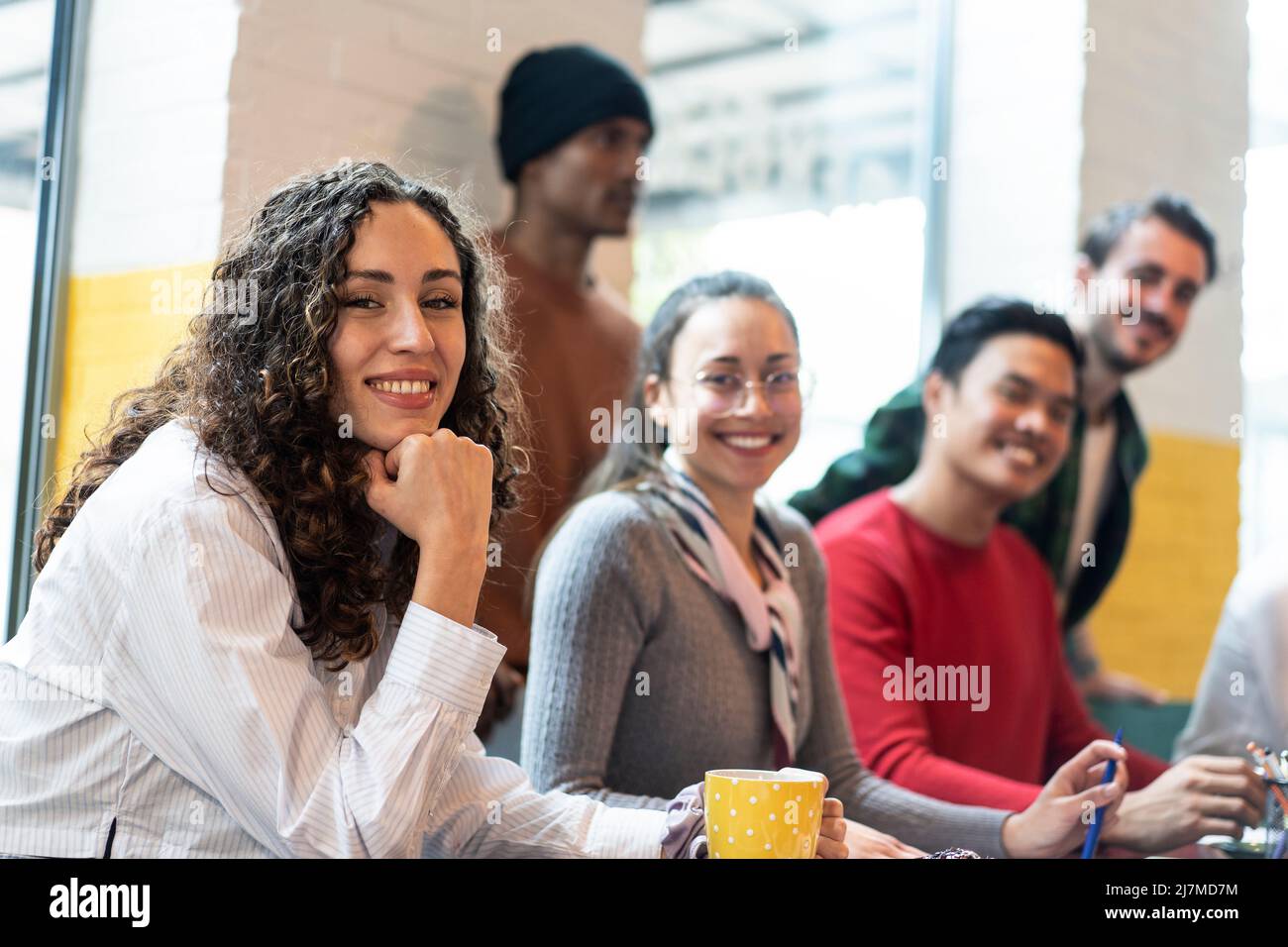 University students multiethnic team studying together on a new project in creative coworking ...