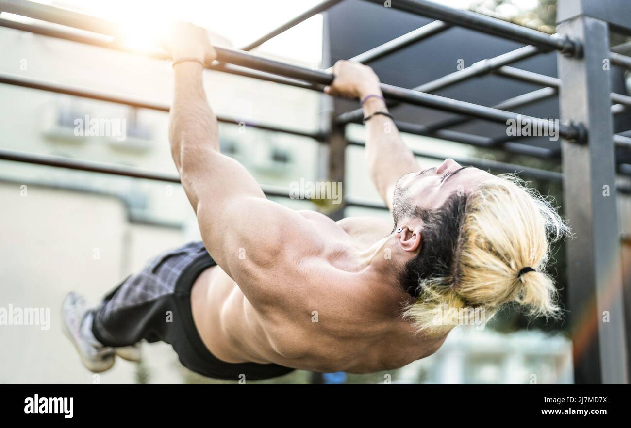 Side view of athletic man exercising calisthenics workout move on ...