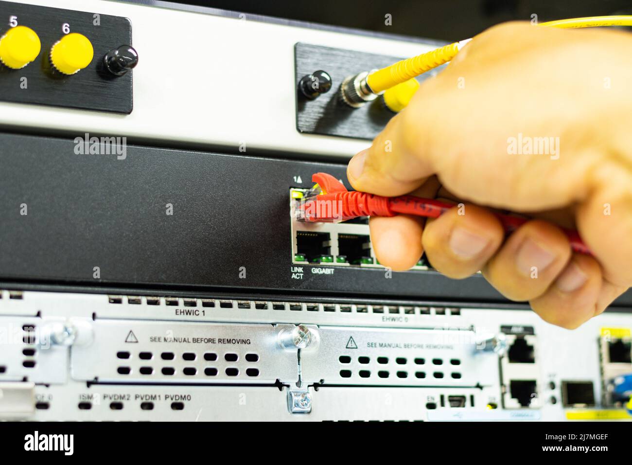 Hand of a man holding The network cables to connect the port of a ...