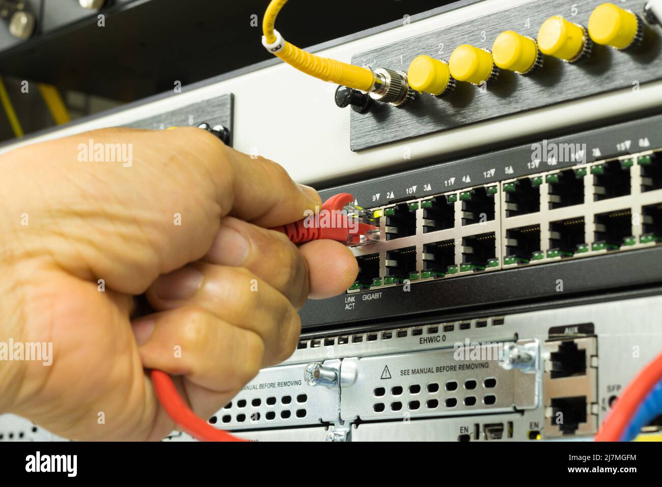 Hand of a man holding The network cables to connect the port of a ...