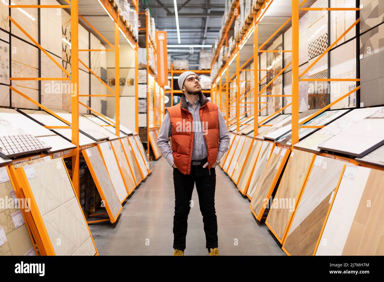 a buyer in a hardware store picks up ceramic tiles Stock Photo - Alamy
