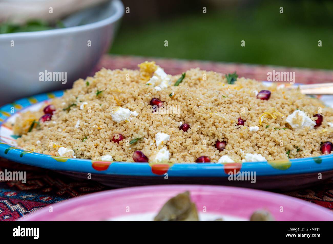 Cous cous and salad on a table in the garden, ready for a party Stock ...