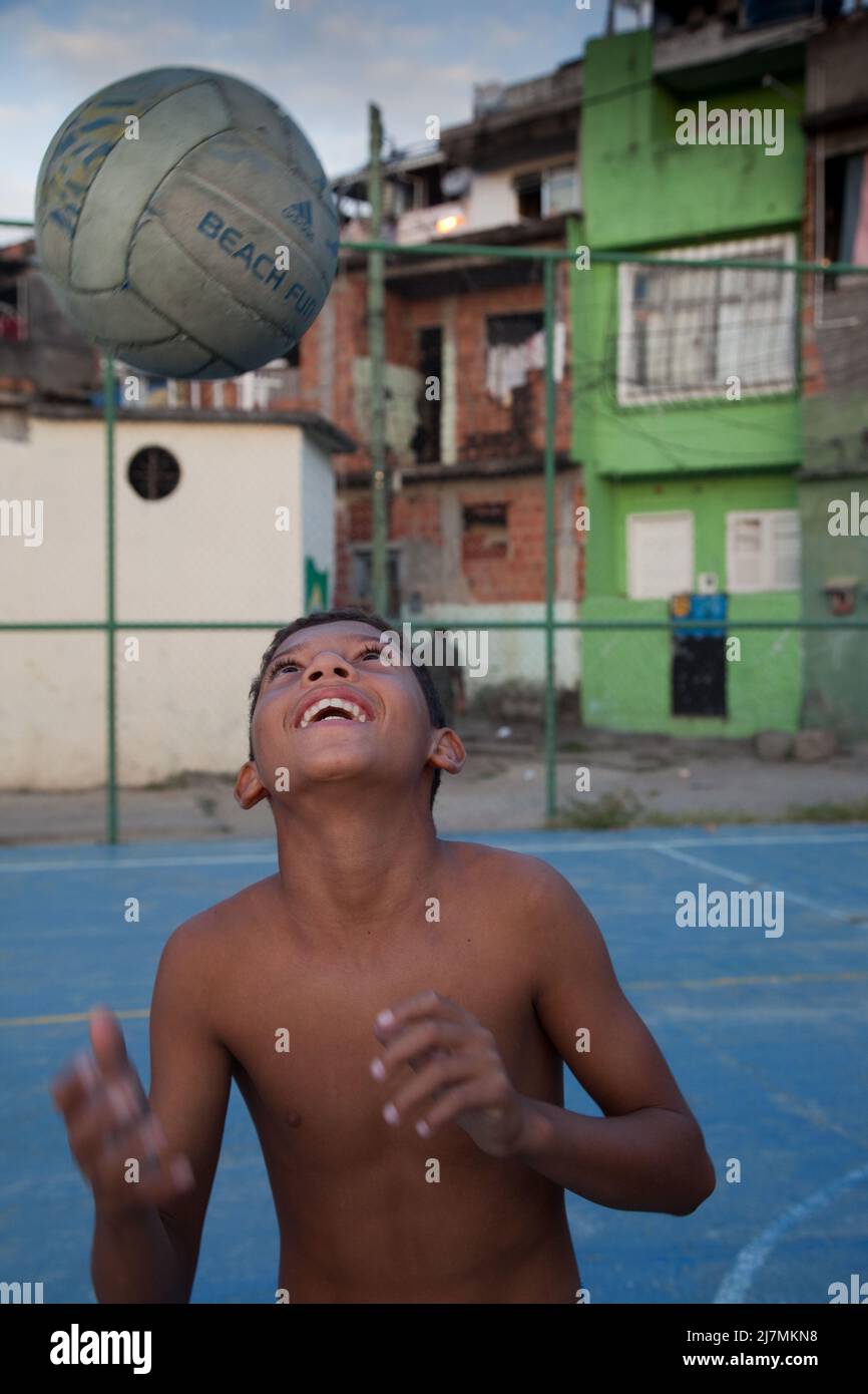 Brazil, Rio de Janeiro, children on a soccer field in one of the many ...