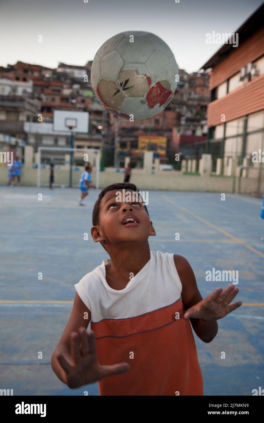 Brazil, Rio de Janeiro, children on a soccer field in one of the many ...