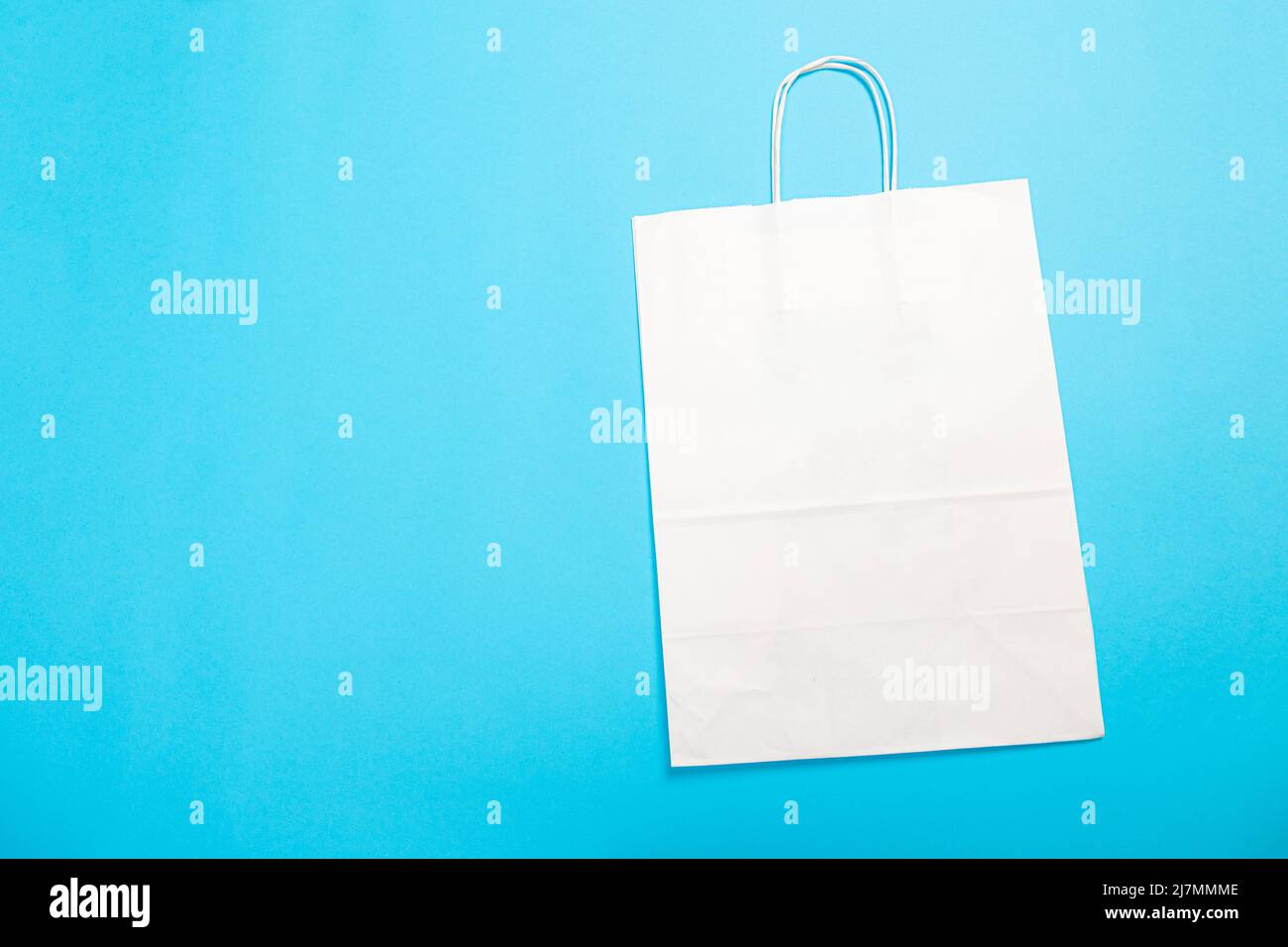 eco blank white paper carry bag with shopping handles facing forward on ...