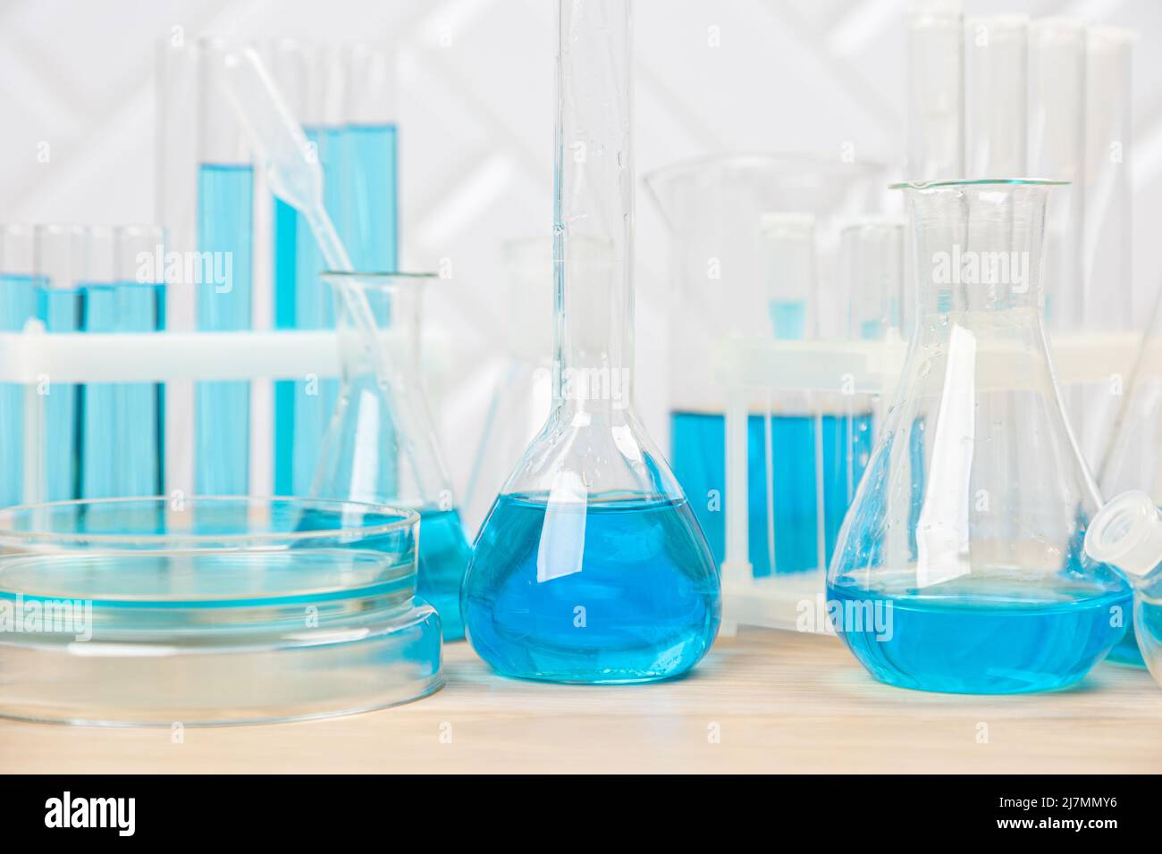 Laboratory glassware with blue liquid in a test tube. scientific ...