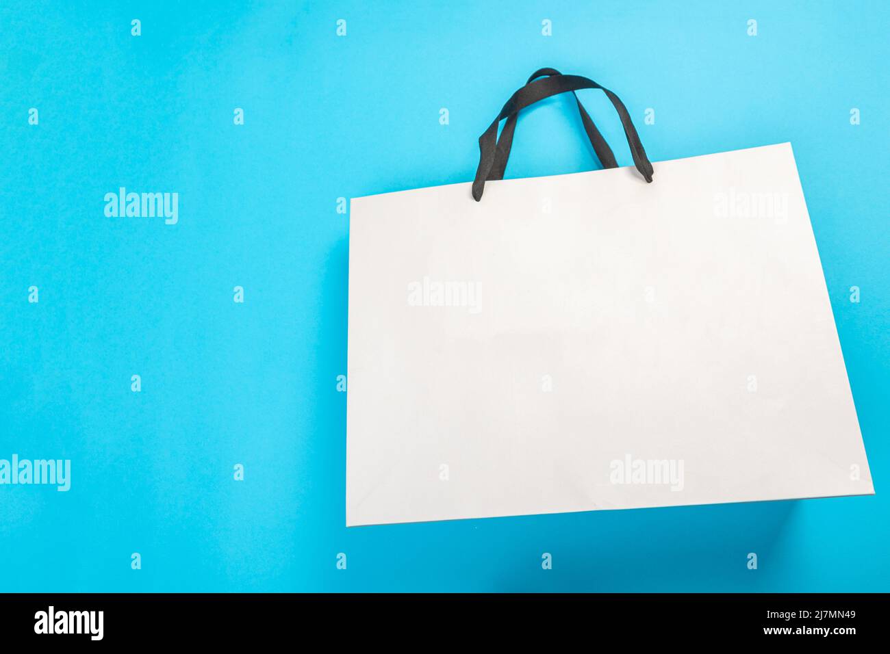 eco blank white paper carry bag with shopping handles facing forward on ...