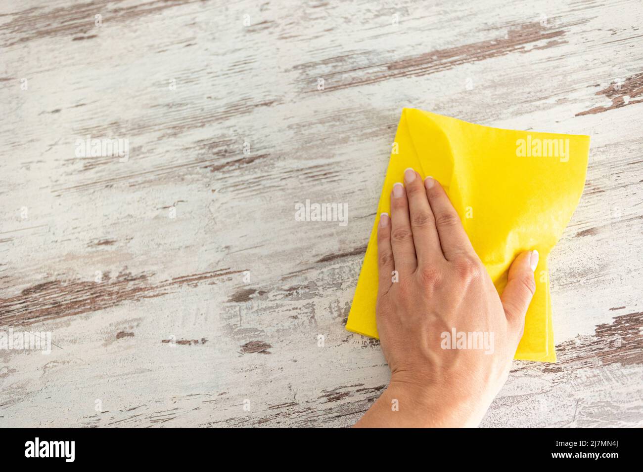 Cleaning yellow napkin in the hands of a woman. cleaning service. The ...