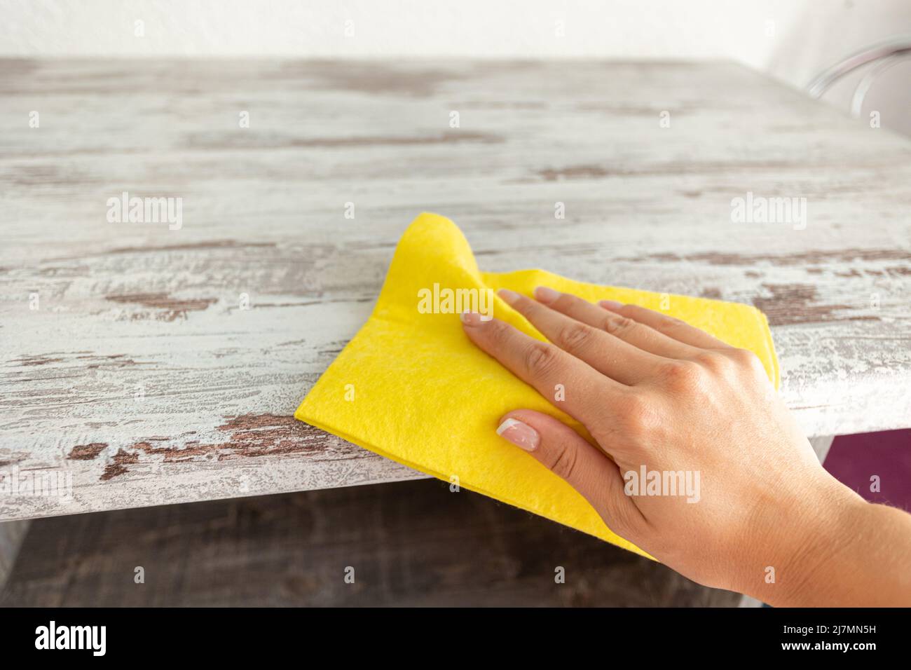Cleaning yellow napkin in the hands of a woman. cleaning service. The ...